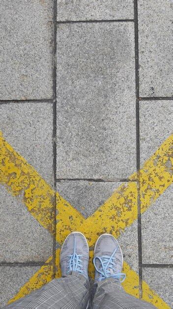 Premium Photo Low Section Of Person Standing On Footpath