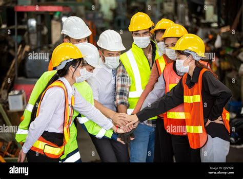 Architect Civil Engineer And Worker Looking At Plans And Blueprints Discussing Issues At The