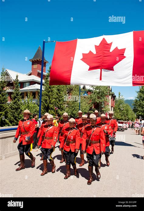 Royal Canadian Mounted Police Officers Parade Under A Canadian Flag In