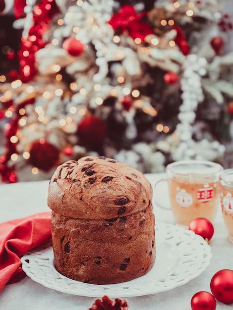 Premium Photo A Christmas Tree Is Behind A Bread Loaf And Two Glasses