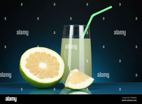 Delicious Sweetie Juice In Glass And Sweetie Next To It On Dark Blue Background Stock Photo Alamy