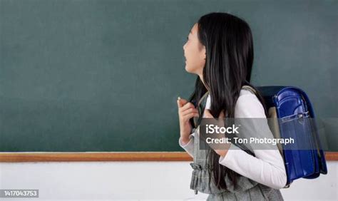 칠판 배경을 가진 학생 뒷 초상화에 학교 가방을 가진 여학생 교실에가는 소녀 학교 초상화의 학생 학교 개념으로 돌아 가기 10