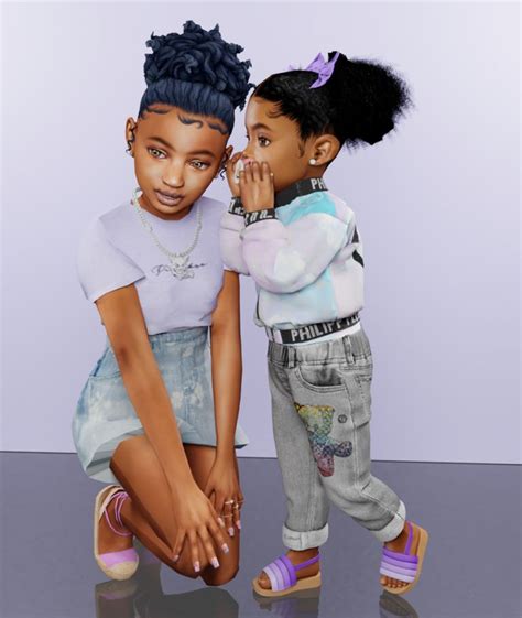 Two Young Black Girls Sitting Next To Each Other