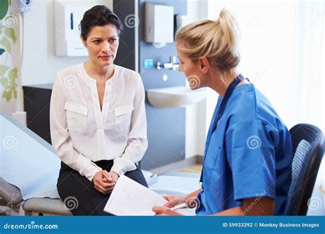 Female Patient And Doctor Have Consultation In Hospital Room Royalty