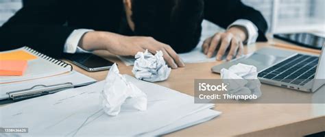 스트레스 사업가는 노트북 컴퓨터와 함께 일하고 사무실 방 배경에 종이의 초점 구겨진 시트와 비즈니스 손실 추상적 인 흐림 후