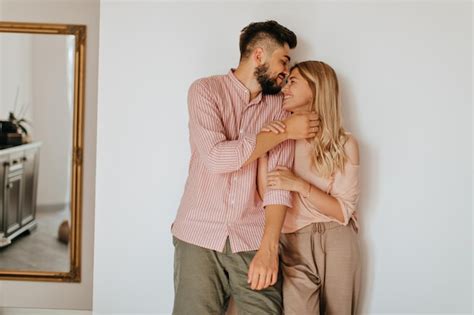 Free Photo Romantic Couple Posing With Smile In Their Bright Living