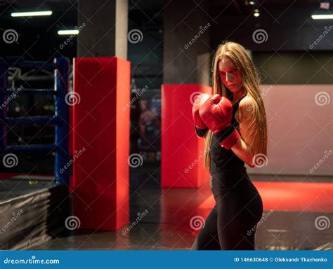Blonde Caucasian Fighter Girl In Red Boxing Gloves Is Posing In Fight
