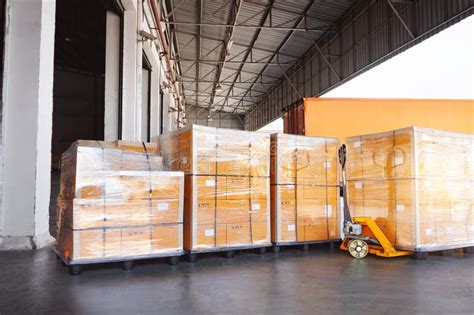 Bulk Of Pallets Boxes Loading Into Shipping Container Package Boxes Wrapped Plastic On Pallets
