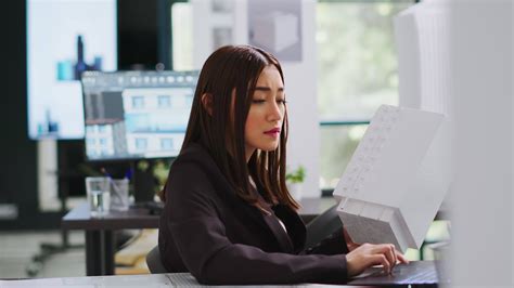 Developer Analyzing 3d Building Model At Realty Office Examining Measurements For The Actual