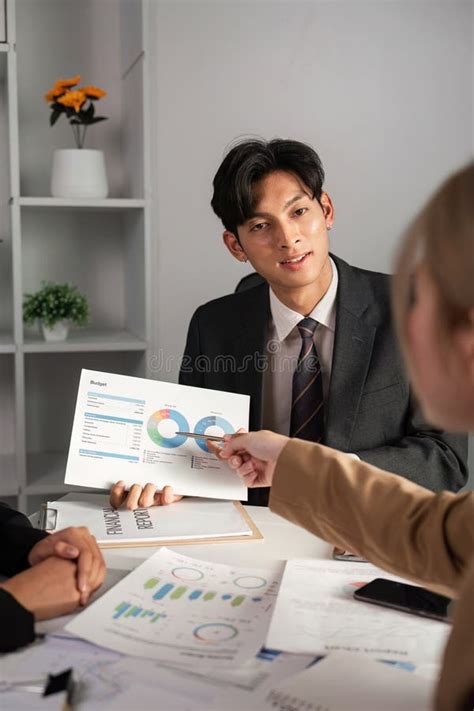 Business Team Collaborates On Data Analysis With Graphs And Charts In