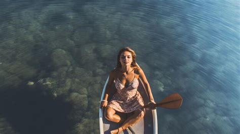Premium Photo Serene Escape A Young Woman Soaking Up The Sun On A Sup