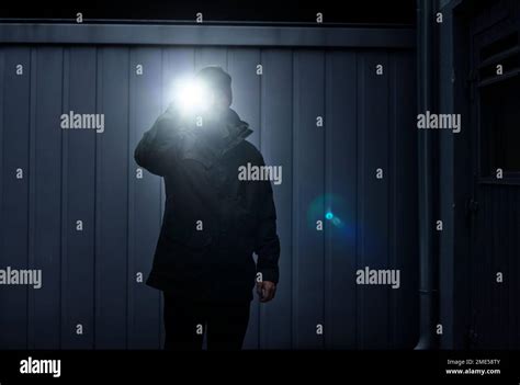 Watchman Searching Site With Torchlight Stock Photo Alamy
