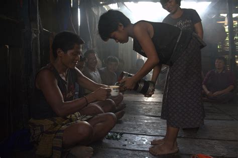 A Young Bhutanese Girl Holding A Trdaitional Jandom And Offers Ara