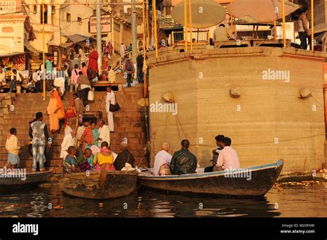 Devotees On The Banks Of The River Ganges Take A Holy Dip In Varanasi