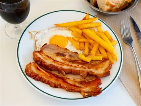 Delicious Breakfast Pork Belly And Fried Eggs With Fries Closeup