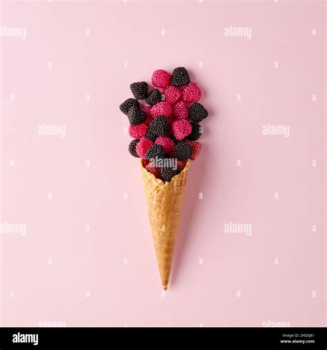 Ice Cream Cone With Spilled Raspberry Or Berries On Pastel Pink