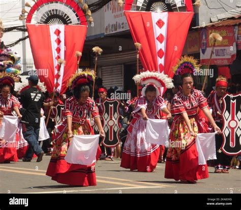Women Dressed In Red National Costumes Dancing In A Parade At Kaamulan