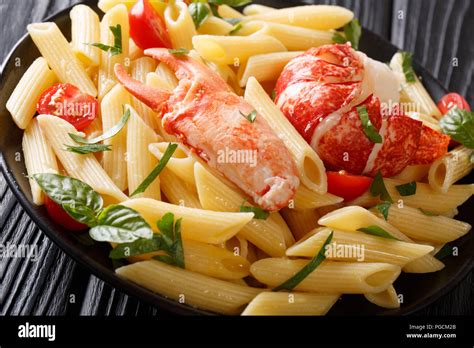 Delicious Penne Pasta With Red Lobster Meat Tomatoes And Fresh Herbs