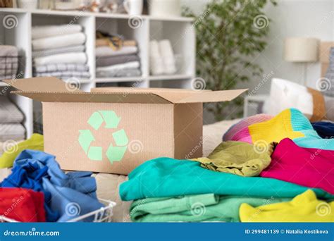 A Stack Of Clothes In Different Colors In A Box With A Recycle Sign Stock Image Image Of