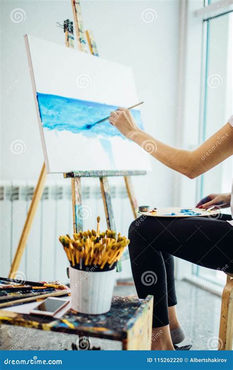 Painter European Girl Drawing Sea Scape On Canvas In Her Workshop