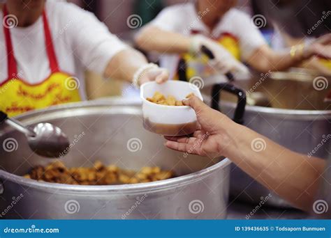 Concept Charity For Homeless With Volunteers Donating Feeding Free Food