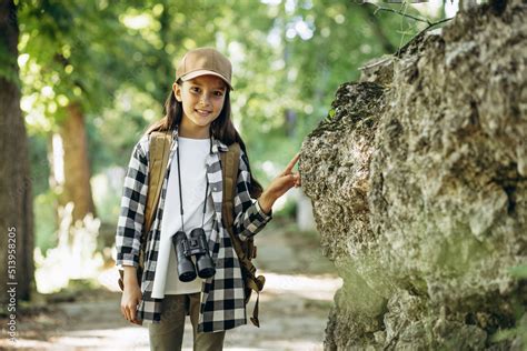 Young Girl Scout Exploring Parks With Rucksuck And Binoculars Stock