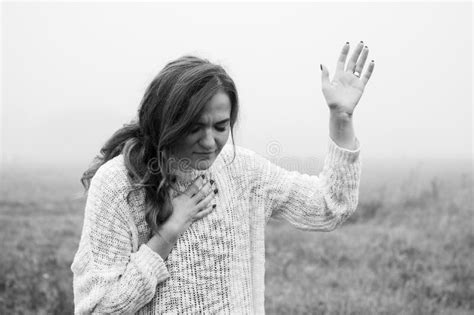 Girl Closed Her Eyes Praying In A Field During Beautiful Fog Hands Folded In Prayer Concept