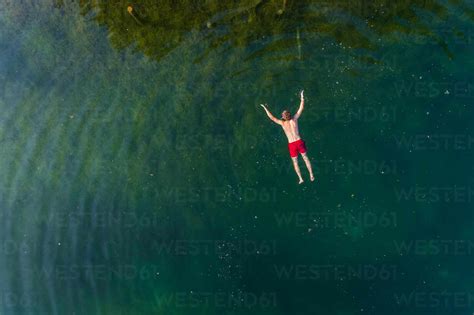 Aerial view of man floating on water at Sinijärv lake in Estonia stock
