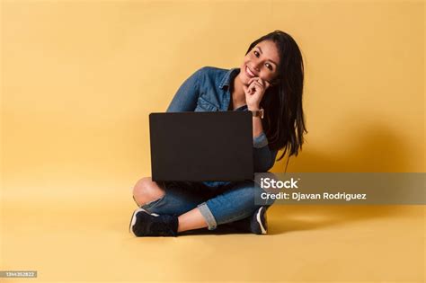 노란색 배경 위에 바닥에 앉아 카메라를보고 노트북을 들고 여자의 전체 길이 노트북에 대한 스톡 사진 및 기타 이미지 노트북 젊은 여자 전신 Istock