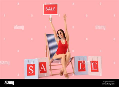 Beautiful Young Happy Woman In Swimsuit With Shopping Bags And Sale