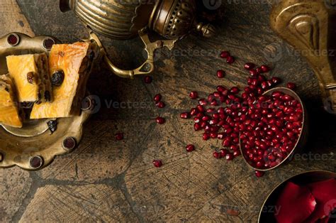 Grains And Seeds Of Pomegranate With A Copper Jug On An Old Decorative Paving Stone An Antique