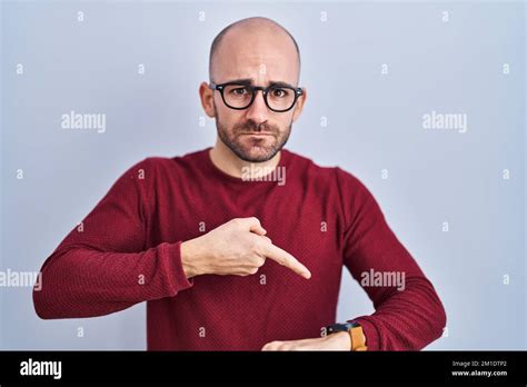 Young Bald Man With Beard Standing Over White Background Wearing