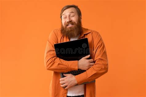 Happy Redhaired Bearded Man Hugging His Laptop Computer Orange Studio Stock Image Image Of