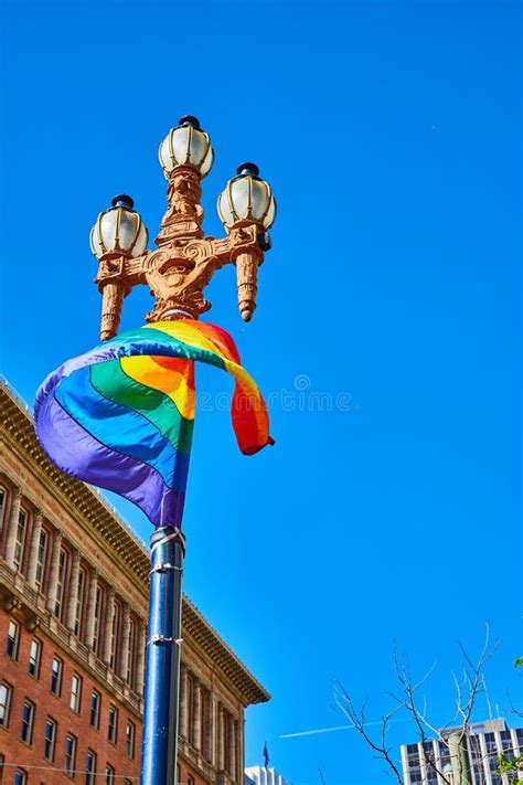 Lgbtqia Rainbow Flag Curled Around As It Flaps Happily In The Wind On