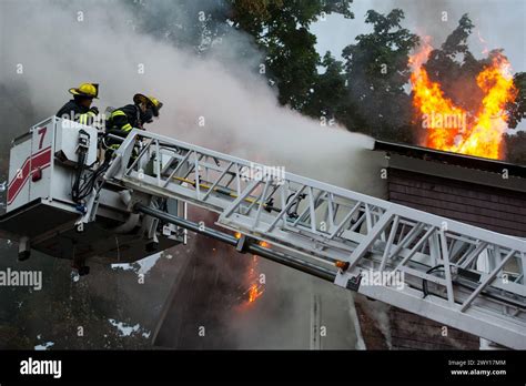 Firefighters Work To Extinguish A Multiple Alarm House Fire In