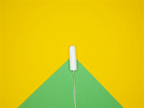 A Nintendo Wii Controller Sitting On Top Of A Green And Yellow Triangle