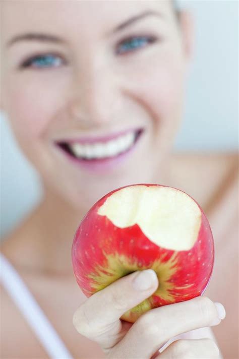 Woman Eating An Apple By Ian Hooton Science Photo Library