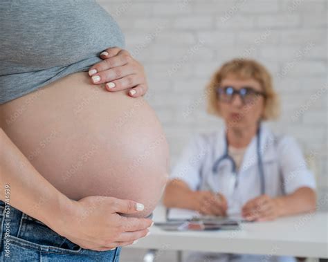 Doctor Obstetrician Gynecologist At His Desk In The Background Close