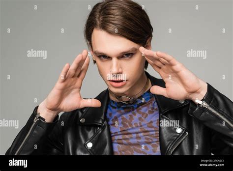 Portrait Of Trendy Bigender Model In Black Leather Jacket Holding Hands