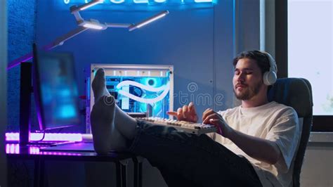 Man Finishes Typing And With A Sense Of Satisfaction Leans Back In
