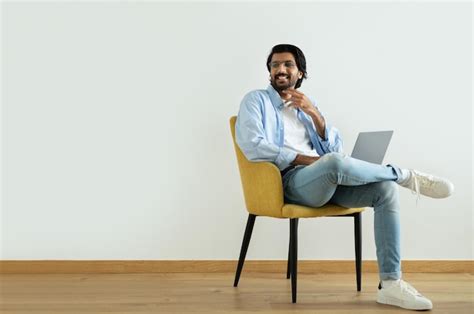Premium Photo Positive Pensive Millennial Middle Eastern Guy In