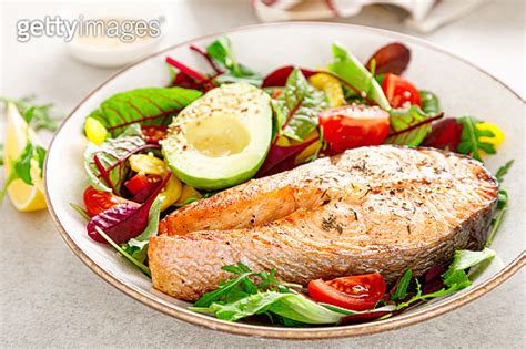 Salmon Fish Steak Grilled Avocado And Fresh Vegetable Salad With