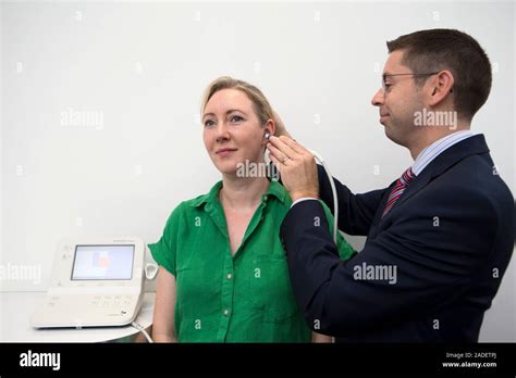 Audiologist Carrying Out A Tympanometry Assessment Using A Handheld Tympanometer This Device Is