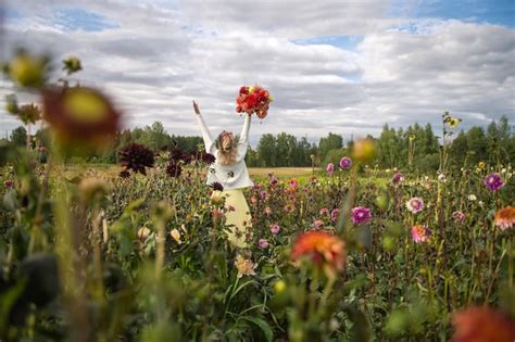 Premium Photo The Girl Raised Her Hands With A Bouquet Up In The Field