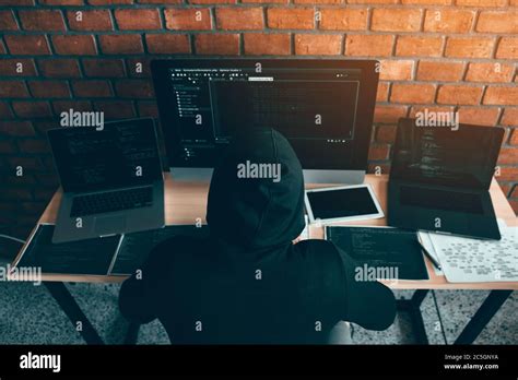 Hacker In The Hood Working With Computer With Hacking Breaking Into