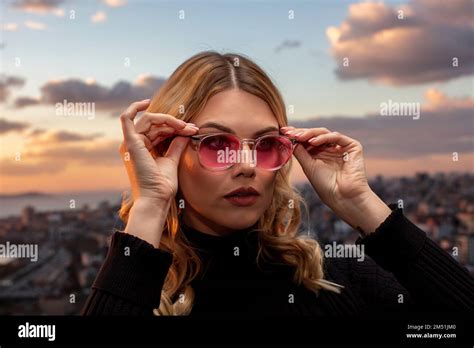 Beautiful Female Model Wearing Colorful Glasses At Sunset Outdoors