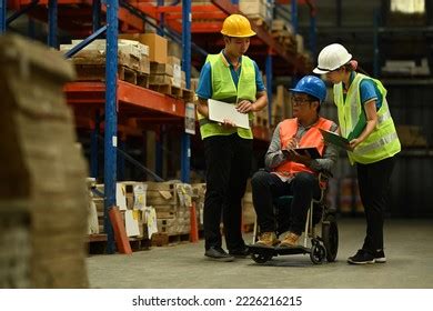 Male Manager Wheelchair Employees Checking Quantity Stock Photo