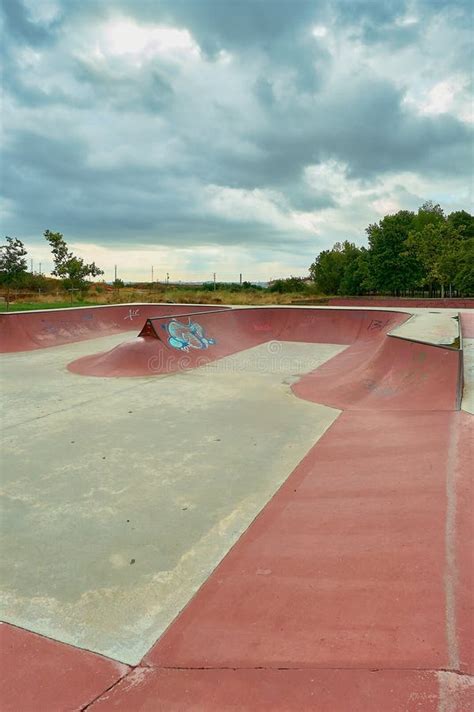 Concrete Skate Park Skate Park Empty With Trees Some Graffiti And Cloudy Sky Editorial Stock