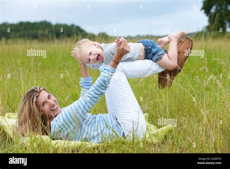 Mother And Son Playing In Grass Stock Photo Alamy