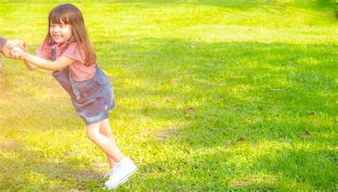 Premium Photo Full Length Of Cute Smiling Girl Standing On Grassy